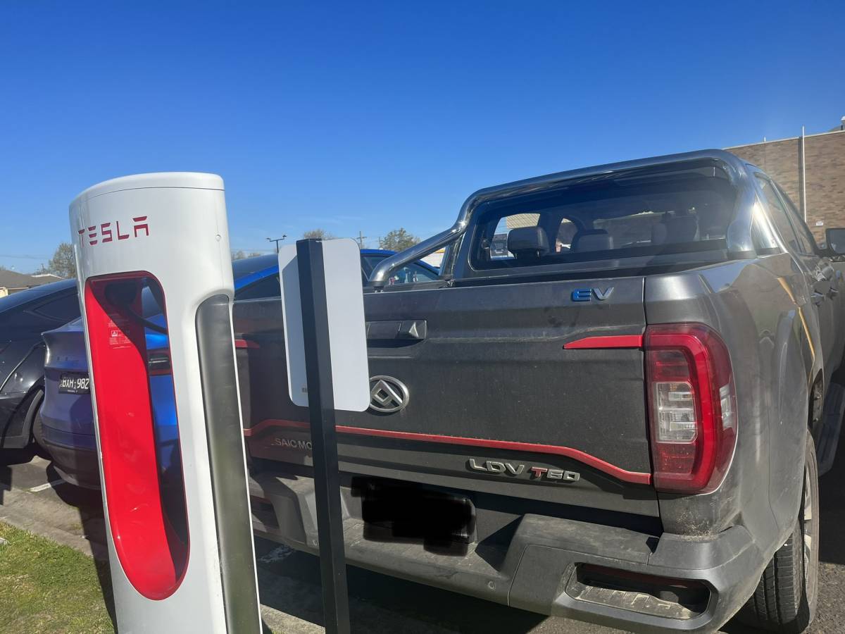 Ute seen charging at a Tesla Supercharger, instead of ICE-ing it