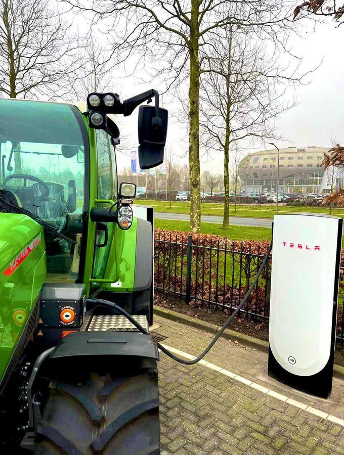 Electric tractor spotted plugged in to a Tesla Supercharger